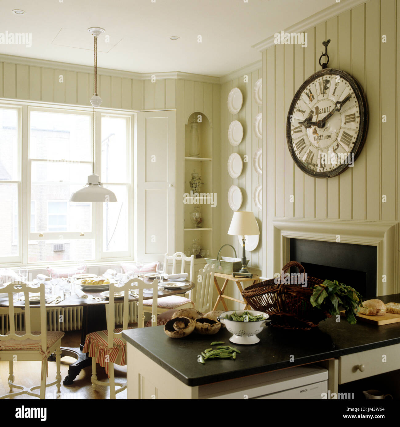 Country style dining room by kitchen Stock Photo - Alamy