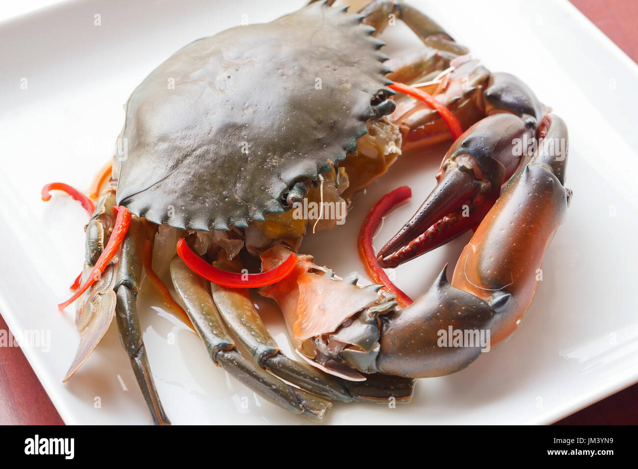 raw mud crab on white dish Stock Photo - Alamy