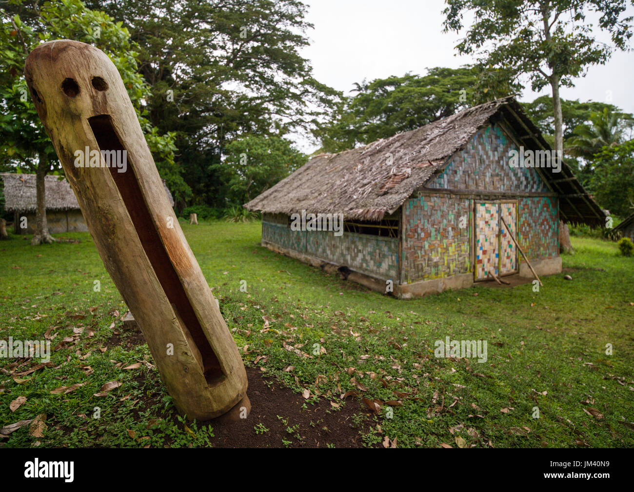 A slit drum in front of a traditional meeting place called a nakamal ...