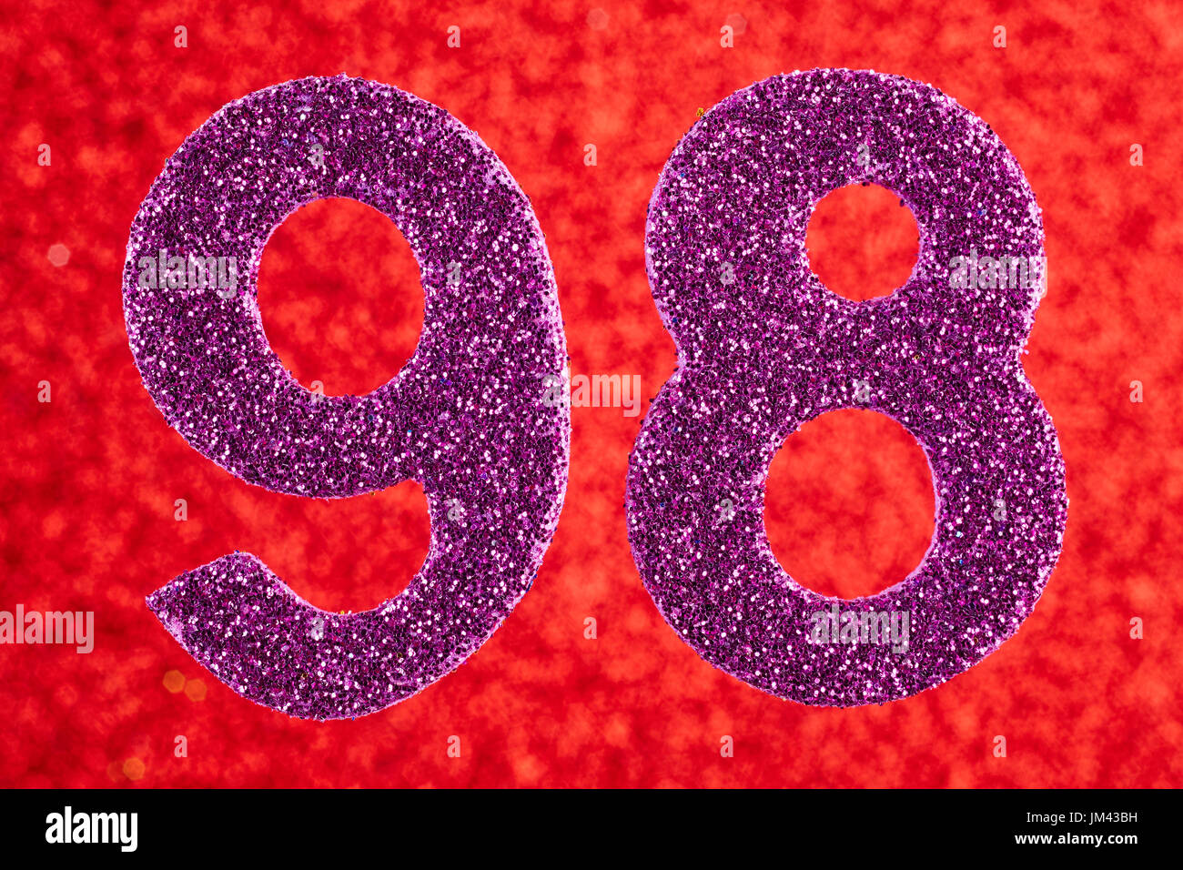 Number ninety-eight purple color over a red background. Anniversary ...