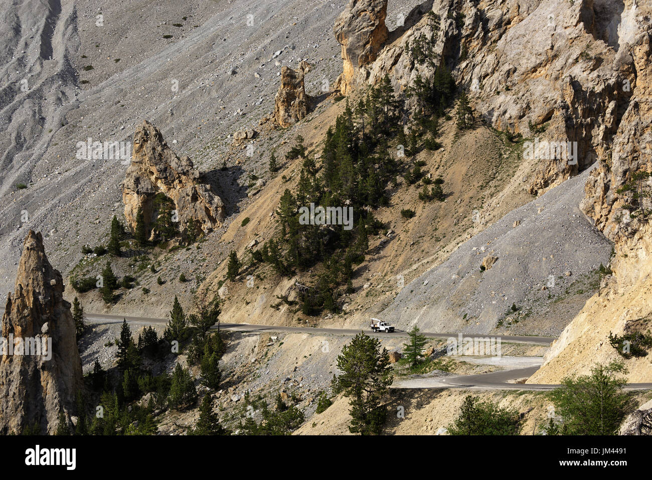 Car driving on mountain road between rock formation in Casse Deserte ...