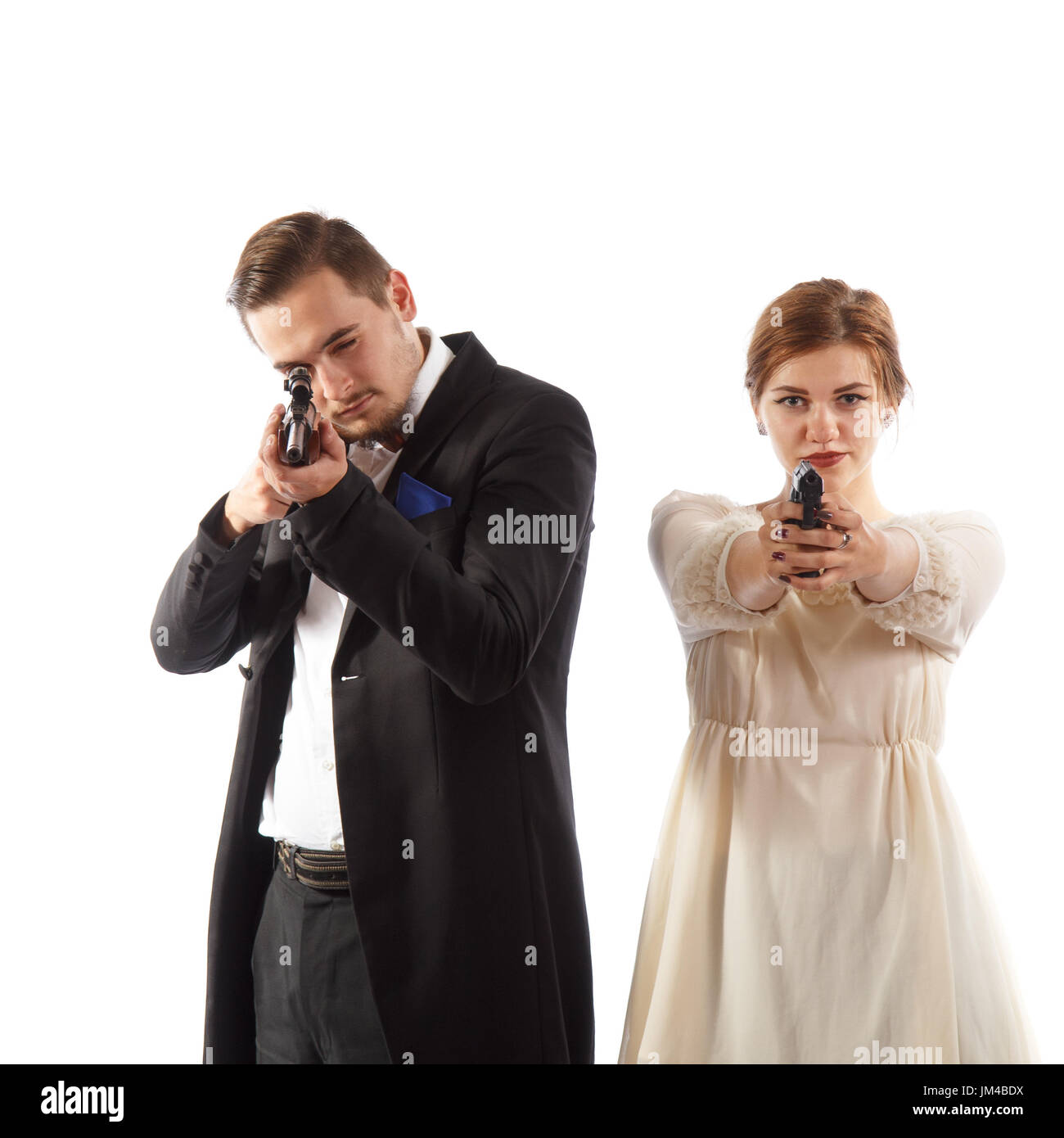 Two well-dressed young mafia couple on white background Stock Photo - Alamy