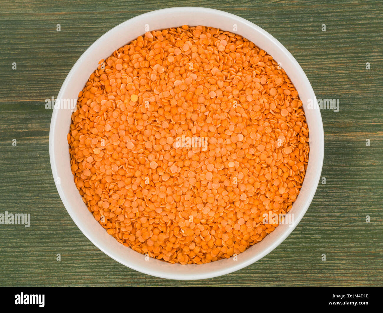 Bowl of Dry Uncooked Red Lentils Against a Green Wooden Background ...