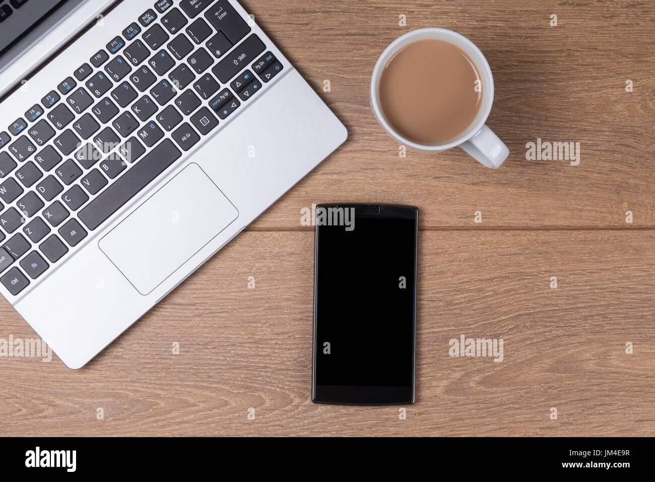 Overhead view on a business workstation on a wooden desk with an open ...