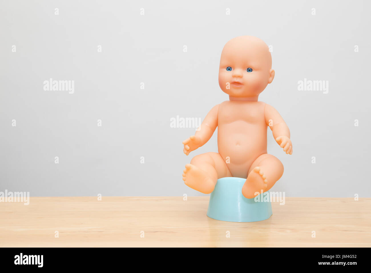 Potty training concept using a doll and toy potty Stock Photo - Alamy