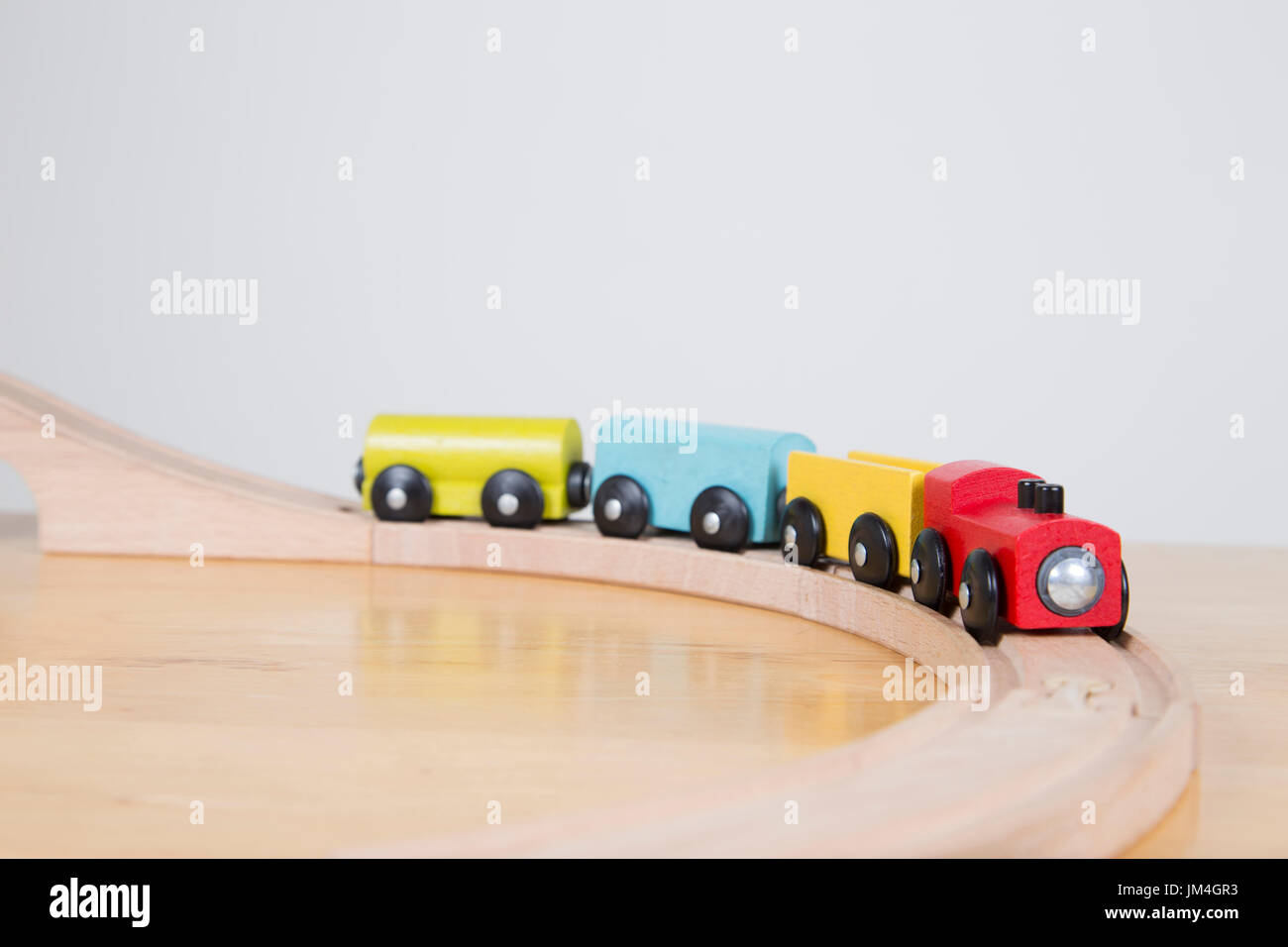 Colorful wooden train set going round a bend Stock Photo - Alamy