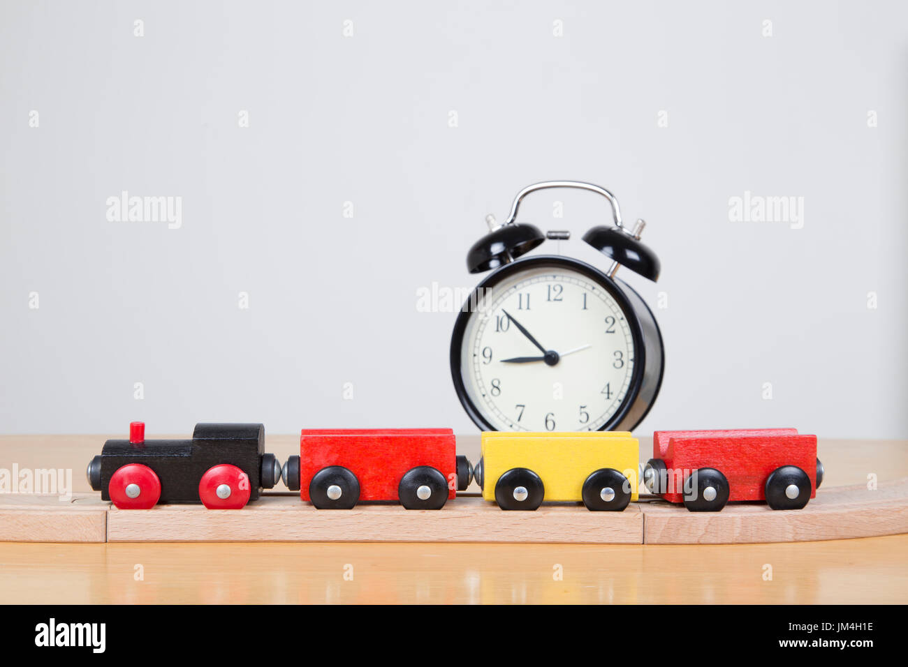Train on time concept - passing a clock Stock Photo - Alamy