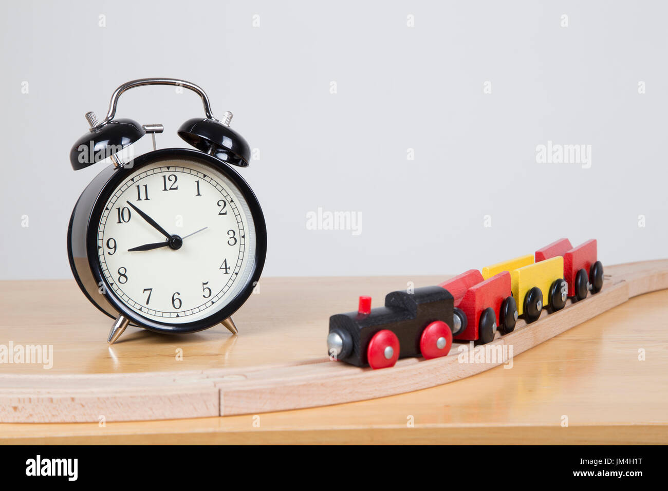 Train going infront of clock, delays concept Stock Photo - Alamy
