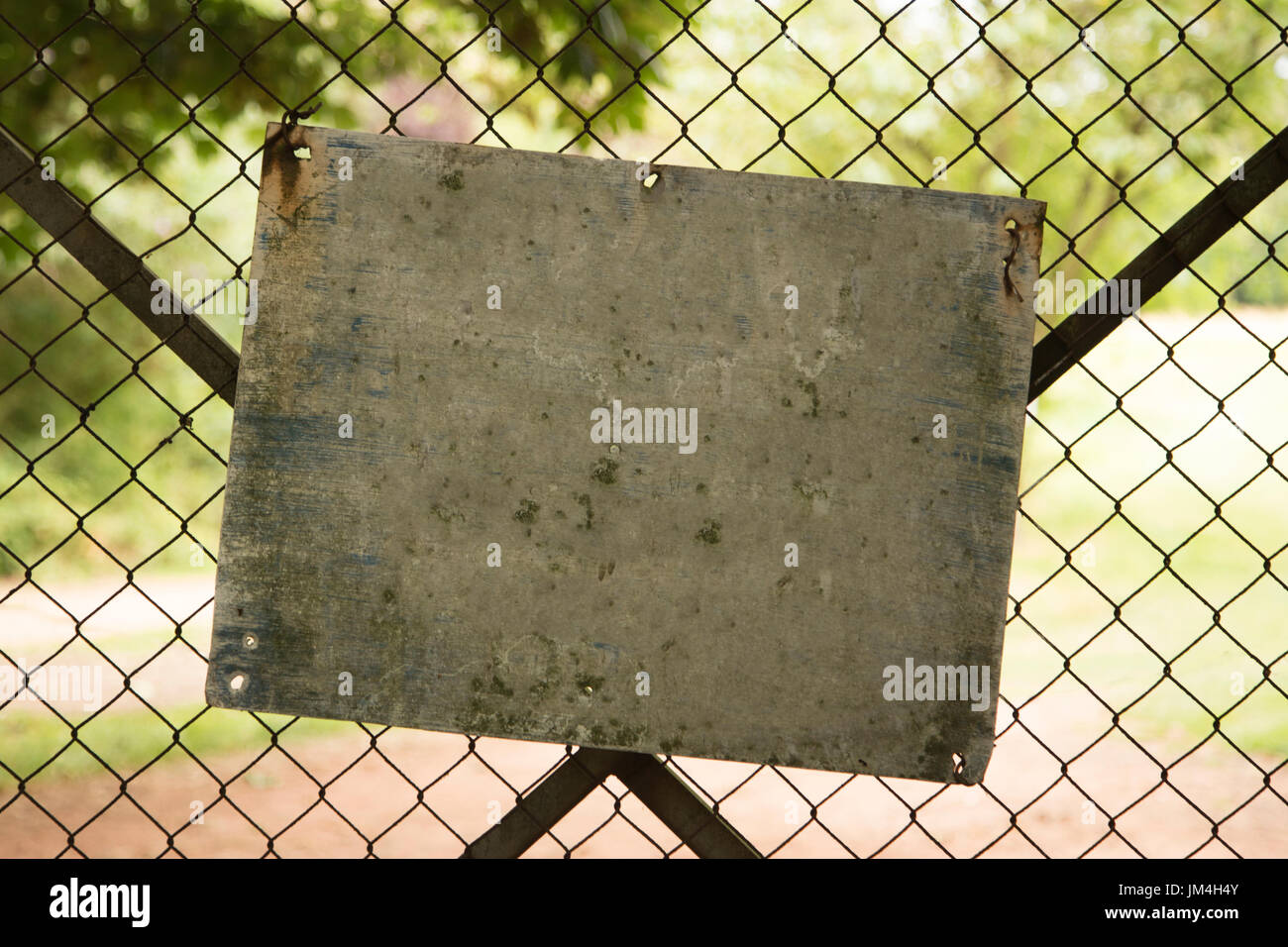 Old and weathered sign on a metal wired fence Stock Photo - Alamy