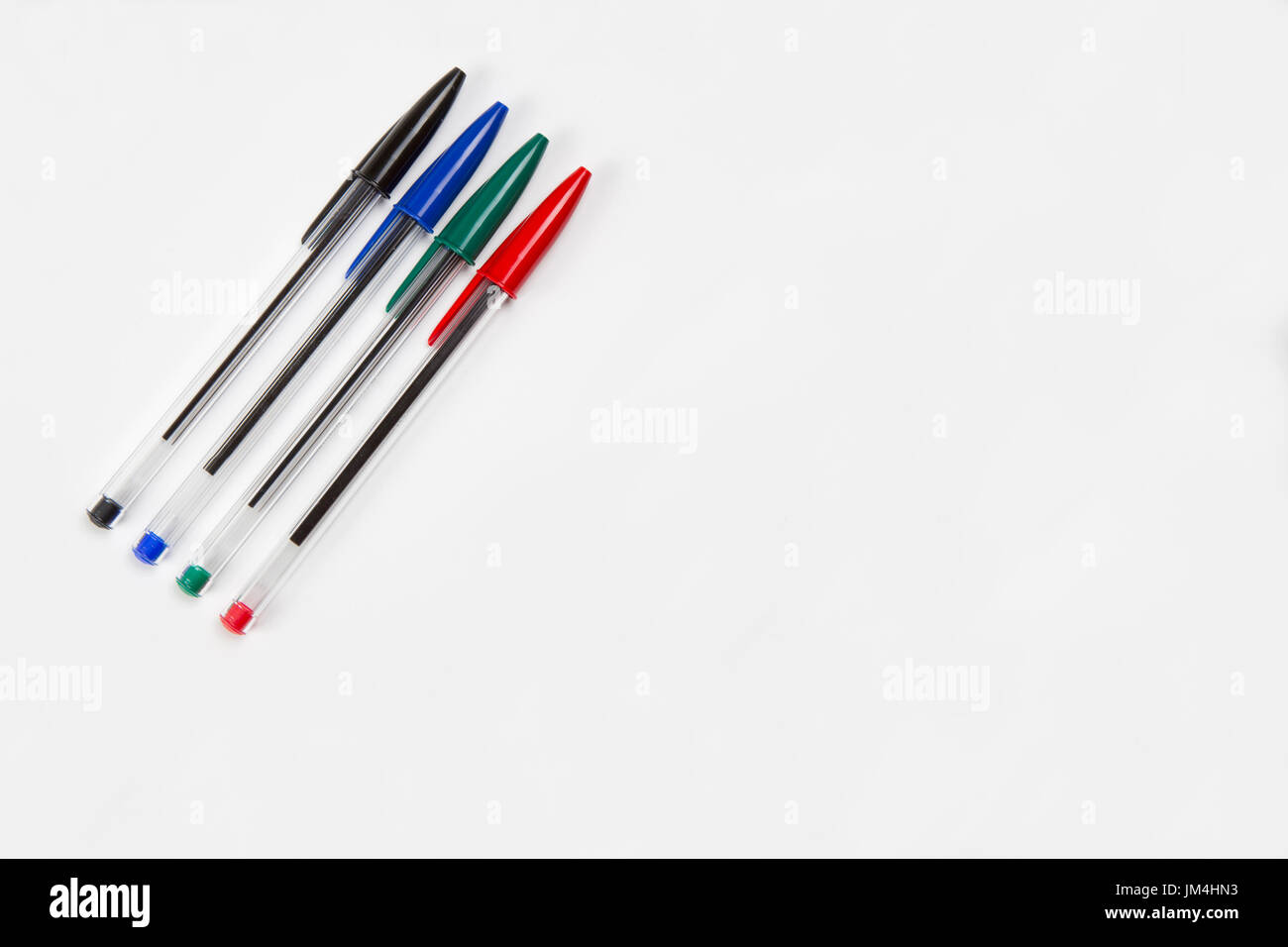 Colored pens angled on white paper Stock Photo - Alamy
