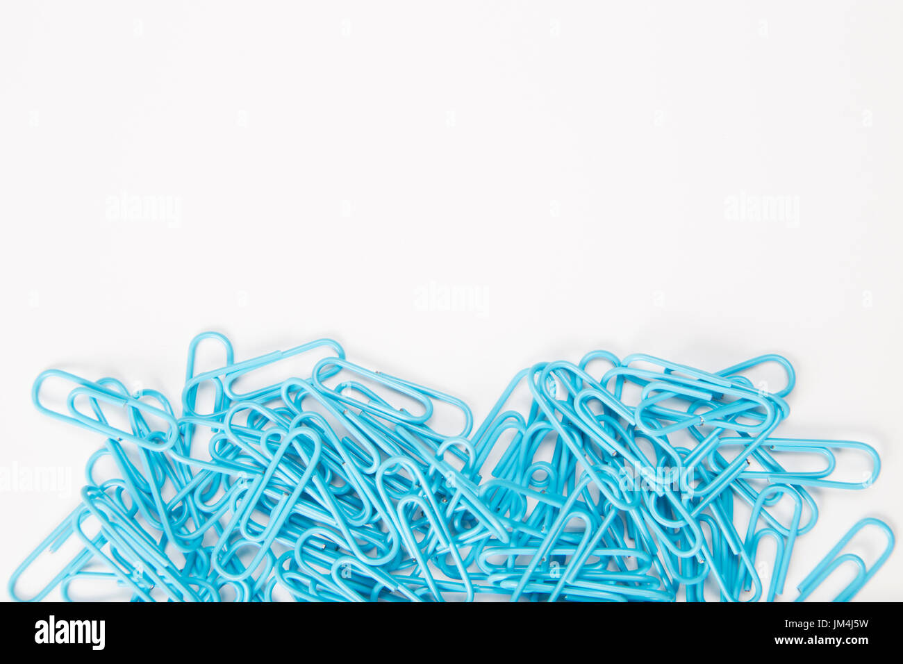 Blue paper clips with copy space Stock Photo - Alamy