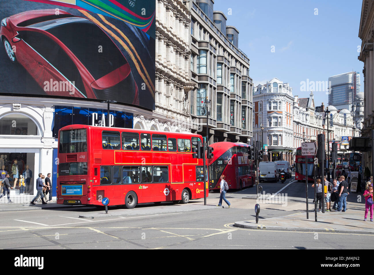 LONDON, UK - AUG 12, 2016. bus passing large screen in piccadilly ...