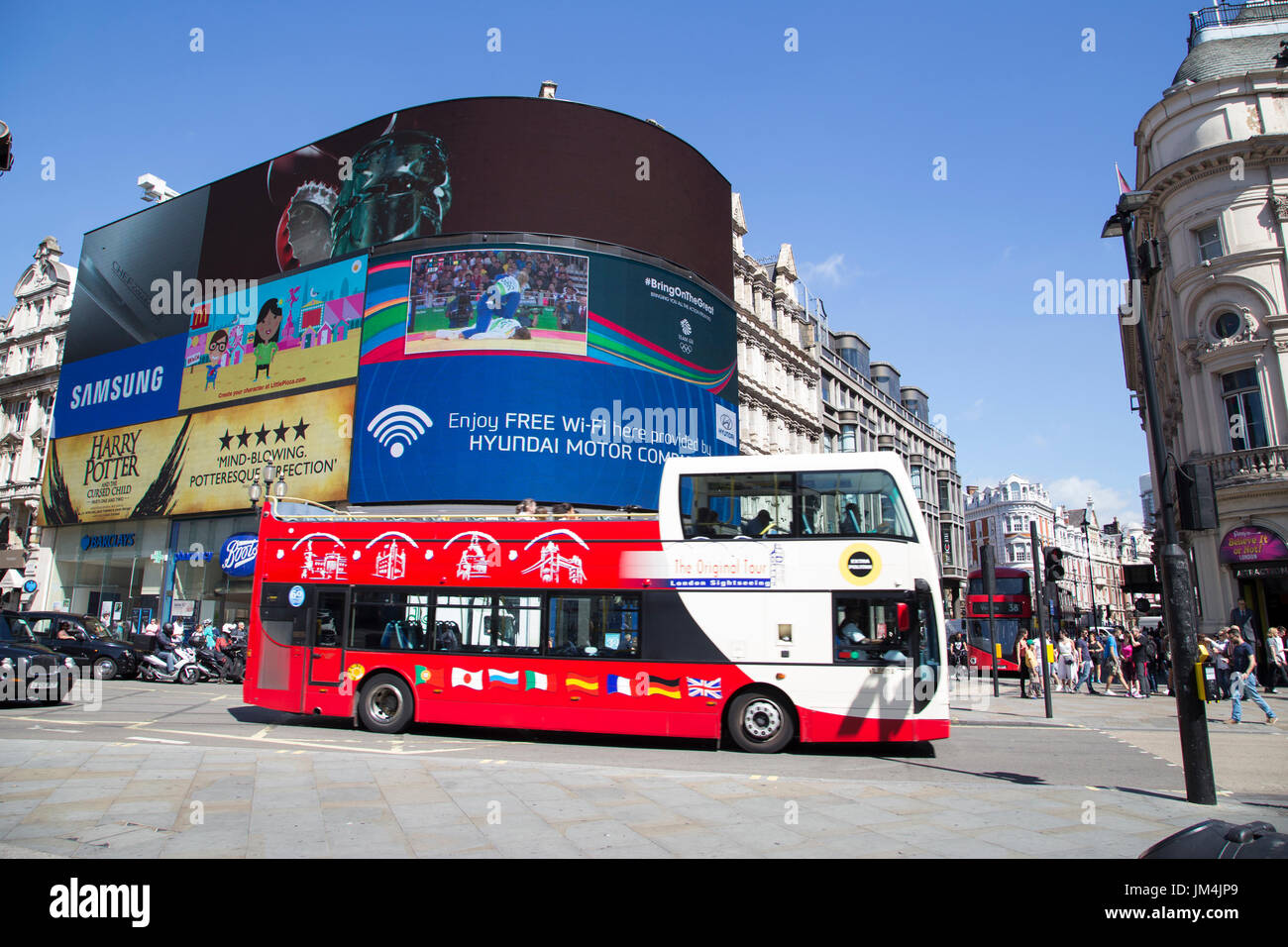 LONDON, UK - AUG 12, 2016. site seeing bus passing big screen in ...