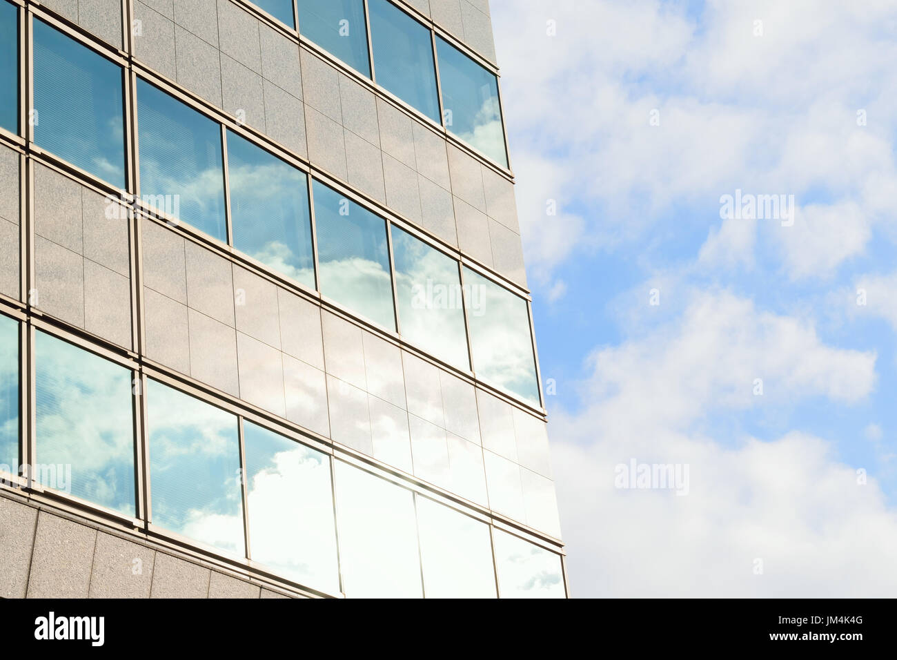 Tall office building in blue sky background Stock Photo - Alamy