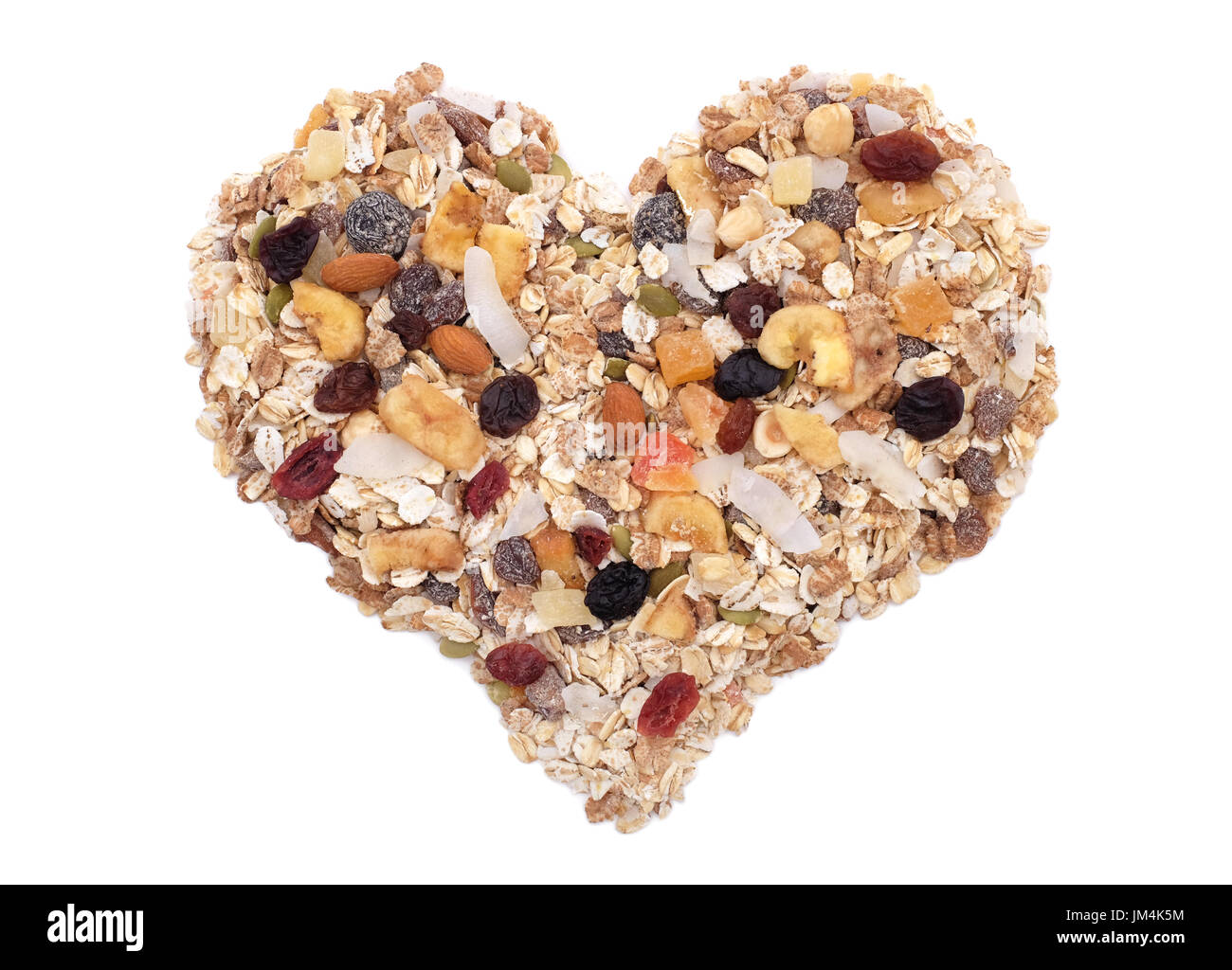 Muesli - cereal flakes with seeds, mixed fruit and nuts - in a heart ...