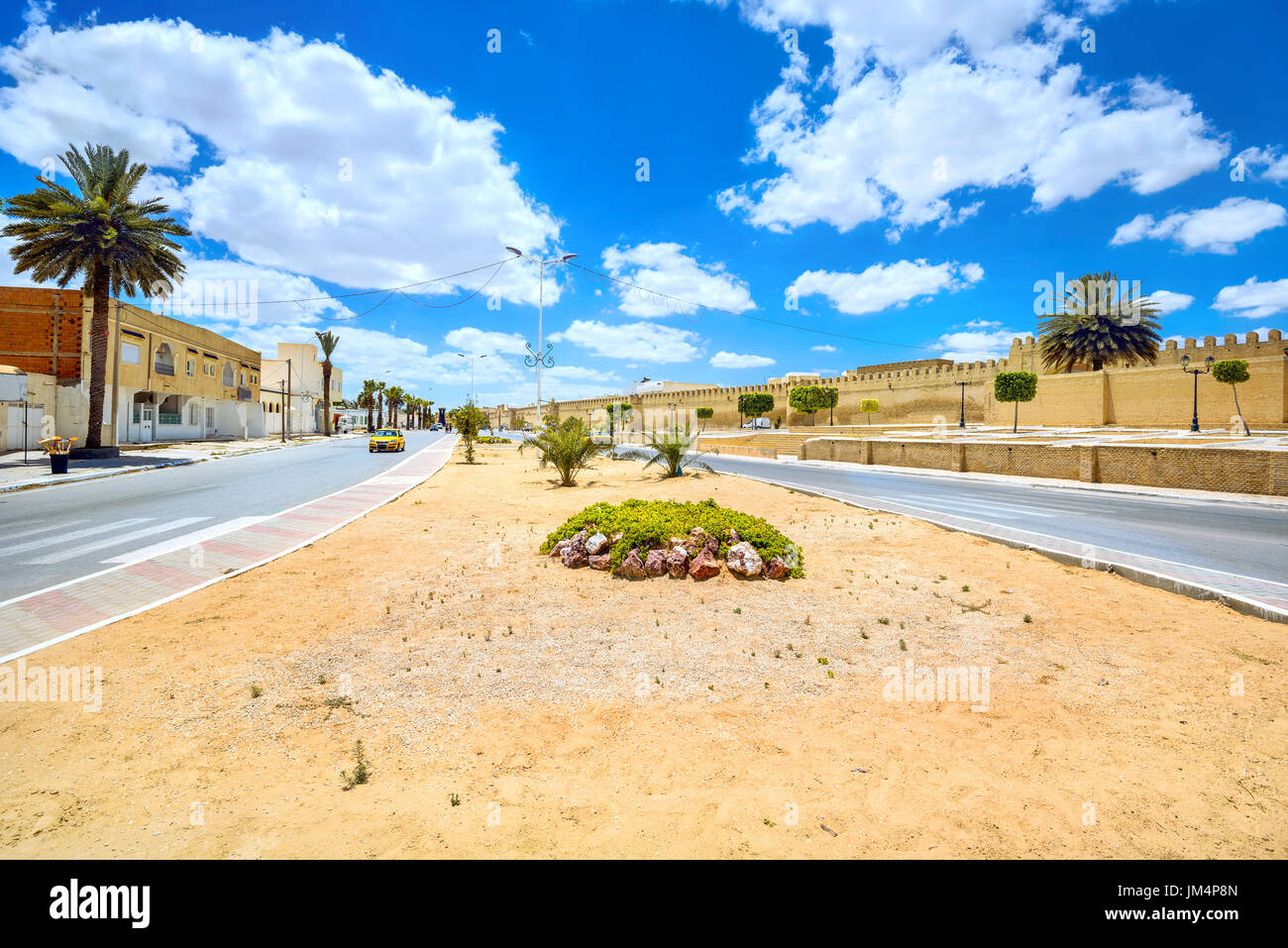 Cityscape with road and wall of Great Mosque in Kairouan city. Tunisia ...