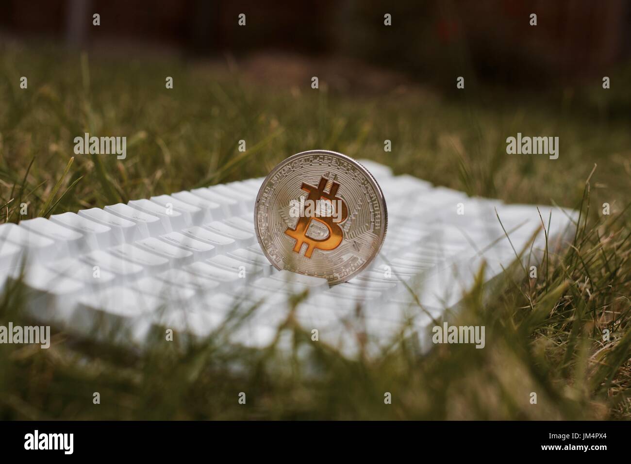Cryptocurrency physical silver bitcoin coin with yellow sign on white ...