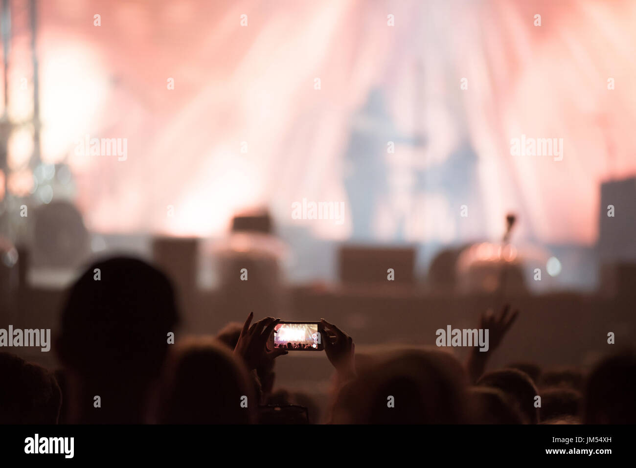 Silhouette of hands recording a concert with smart phones. Crowd of ...