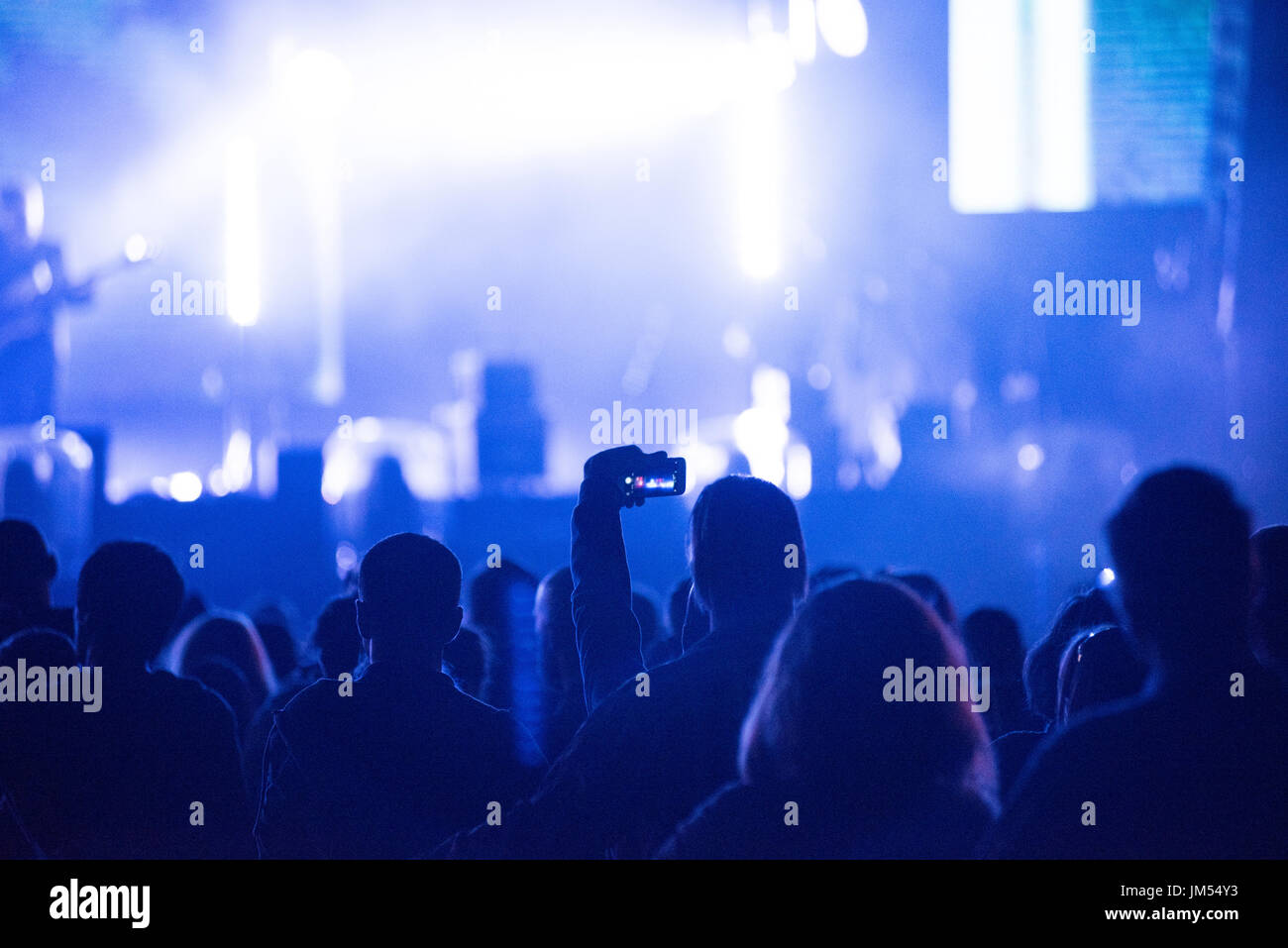 Silhouette of hands recording a concert with smart phones. Crowd of ...