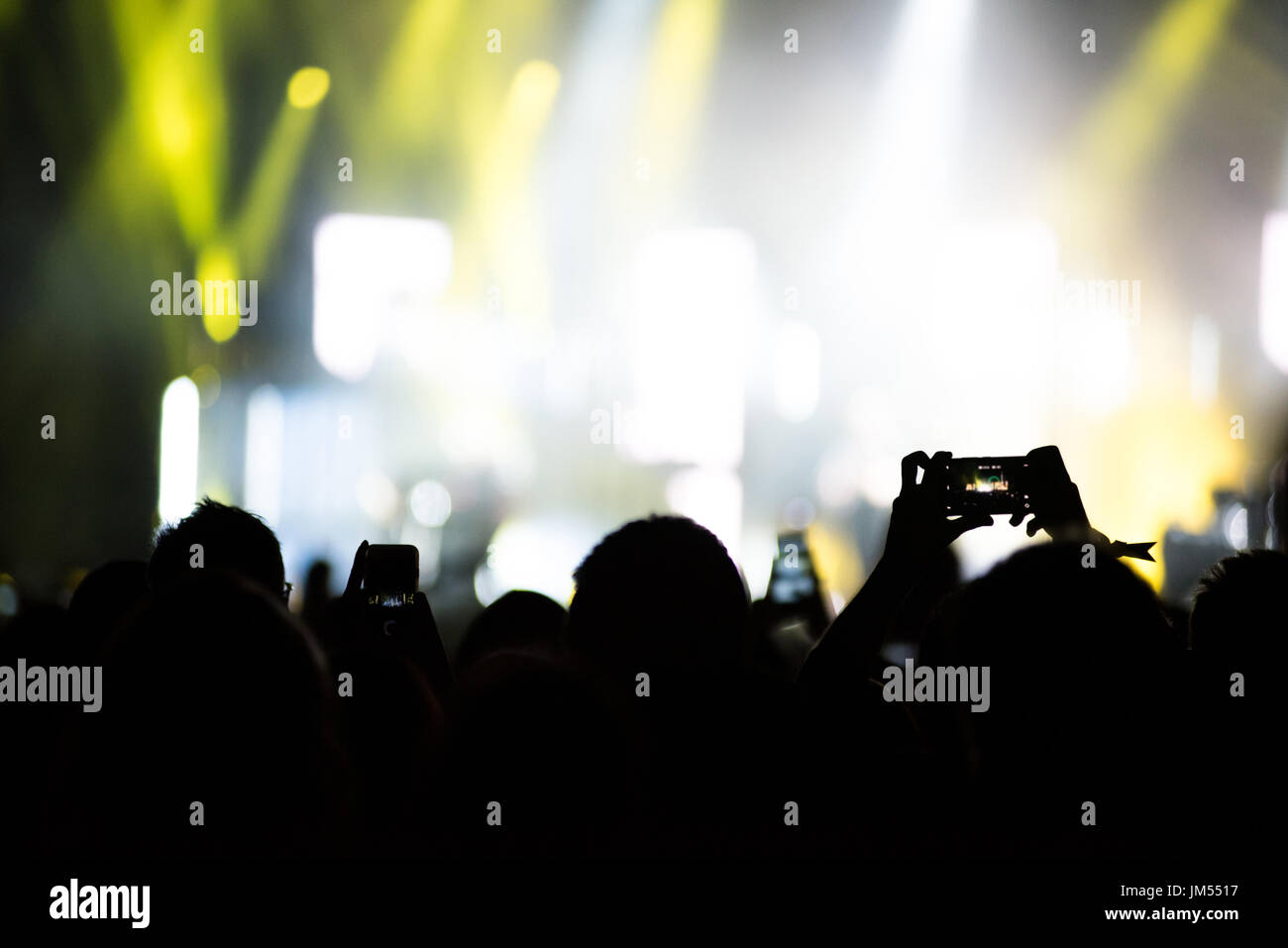 Silhouette of hands recording a concert with smart phones. Crowd of ...