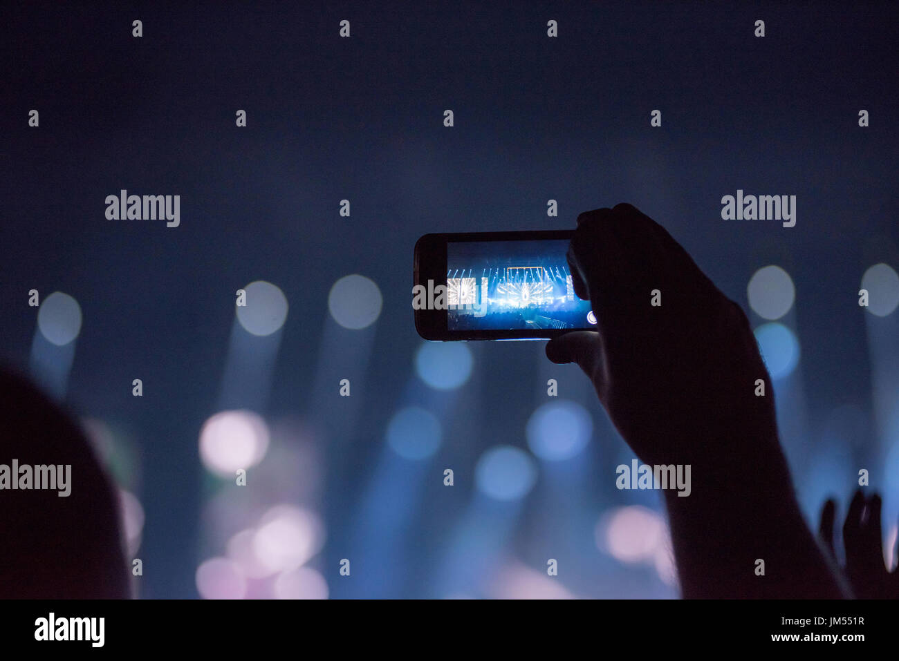 Silhouette of hands recording a concert with smart phones. Crowd of ...