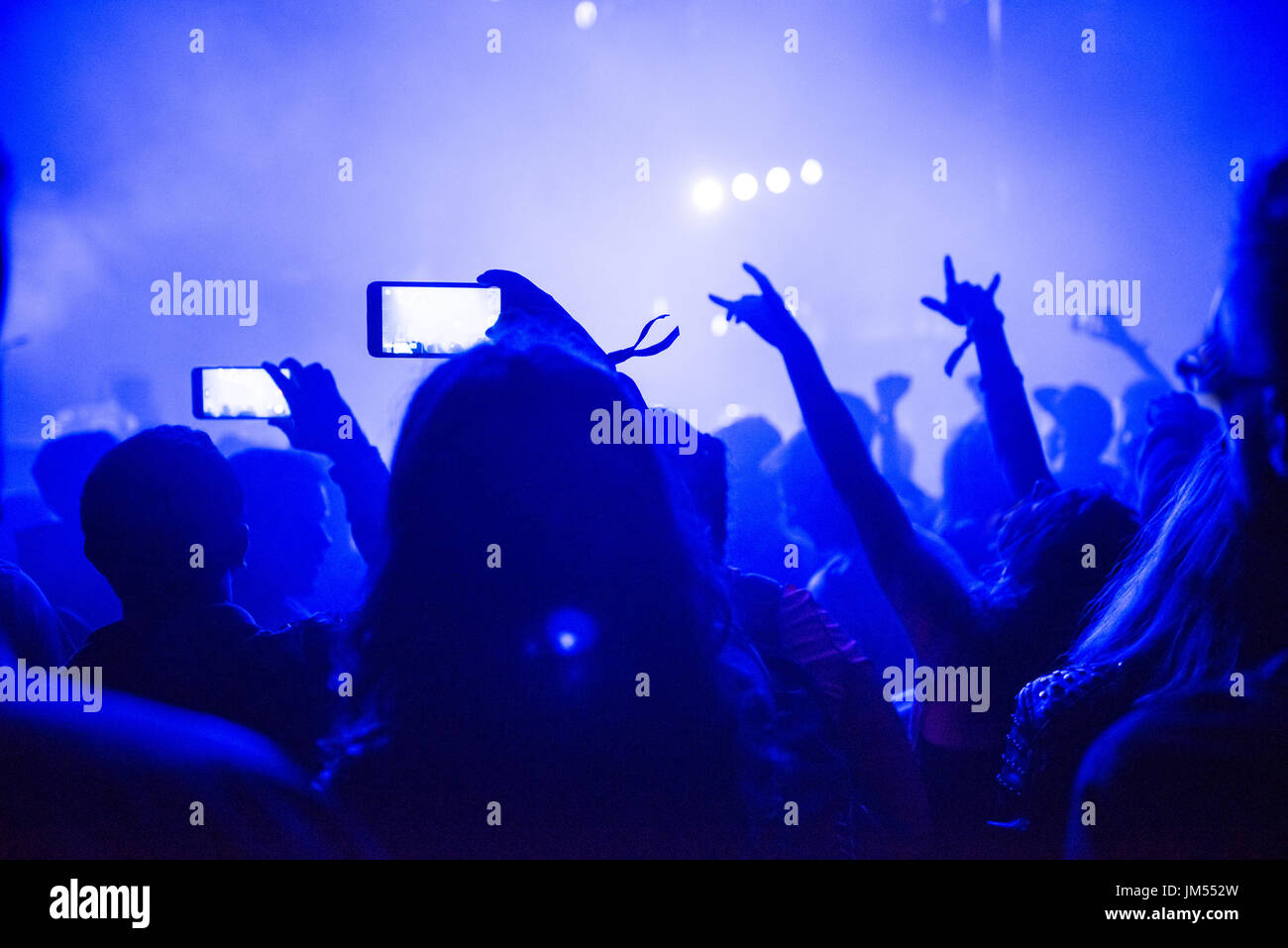 Silhouette of hands recording a concert with smart phones. Crowd of ...