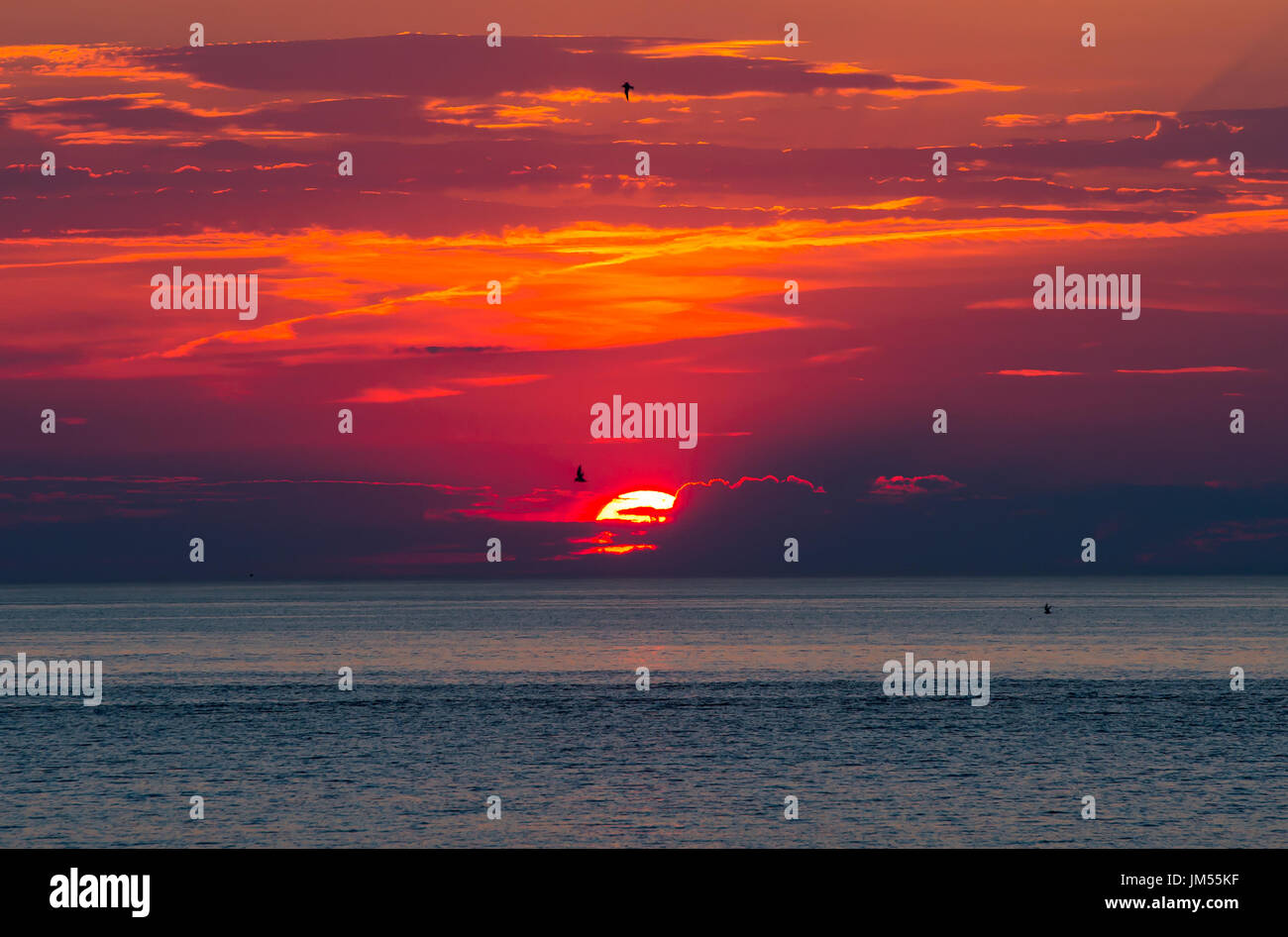 Fiery red sunset over the Atlantic Ocean in Provincetown, MA Stock ...
