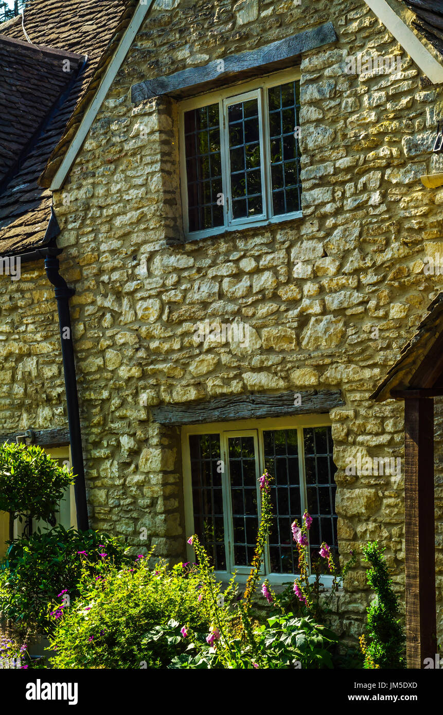 Old wooden window in a historic building, characteristic stone facade ...