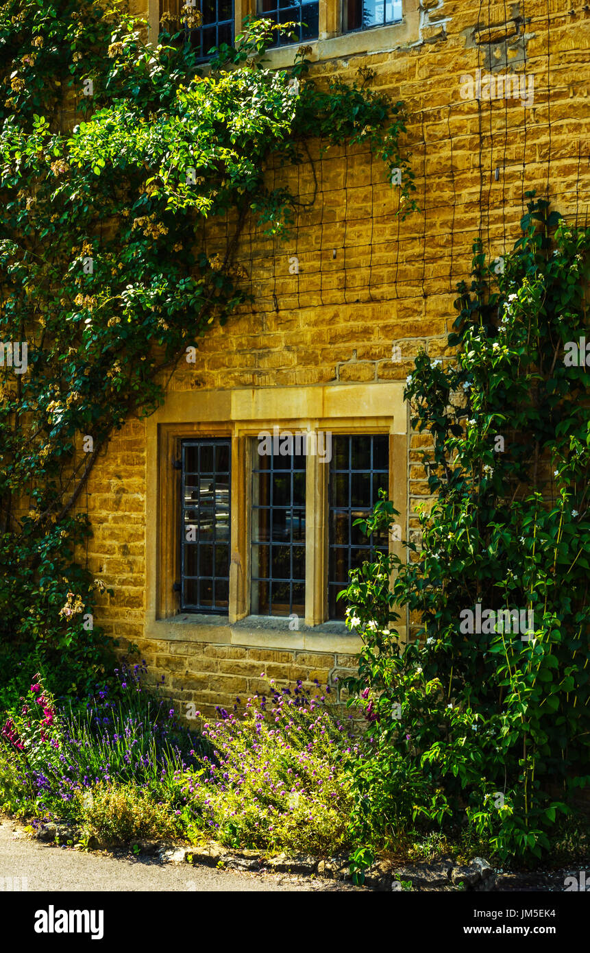 Old wooden window in a historic building, characteristic stone facade ...