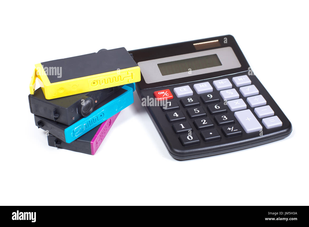 Stack of jet-ink printer cartridges and calculator, symbolising cost of ...