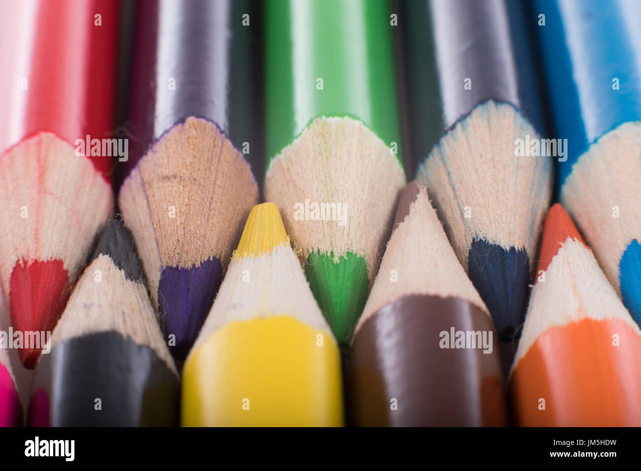 Some crayons interleaved on a horizontal full frame close-up ...