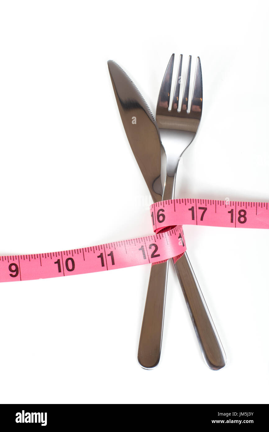 Crossed cutlery fork and knife bandaged with red measuring tape marked ...