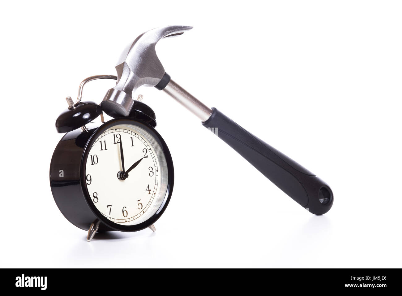Classic alarm clock hit by hammer tool with black handle isolated on ...