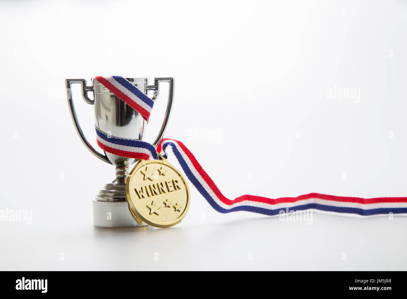 first place winner medal and trophy on white background Stock Photo - Alamy