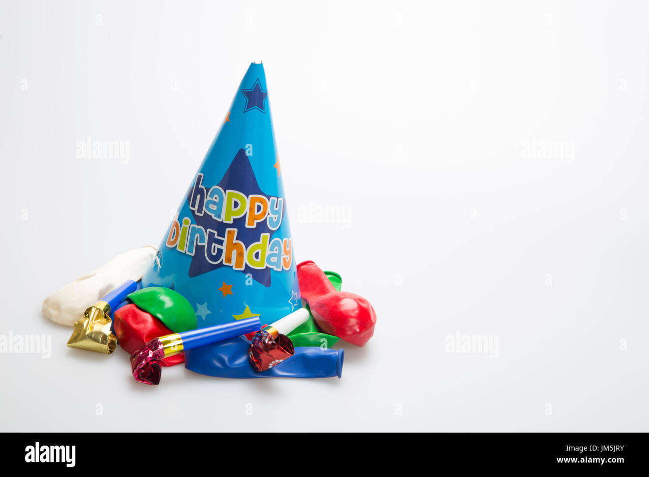 Blue party hat on a white background with ballons and party blowers ...