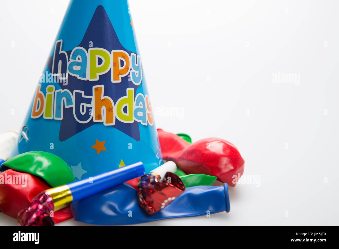 boys birthday party hat with balloons and party blowers Stock Photo - Alamy