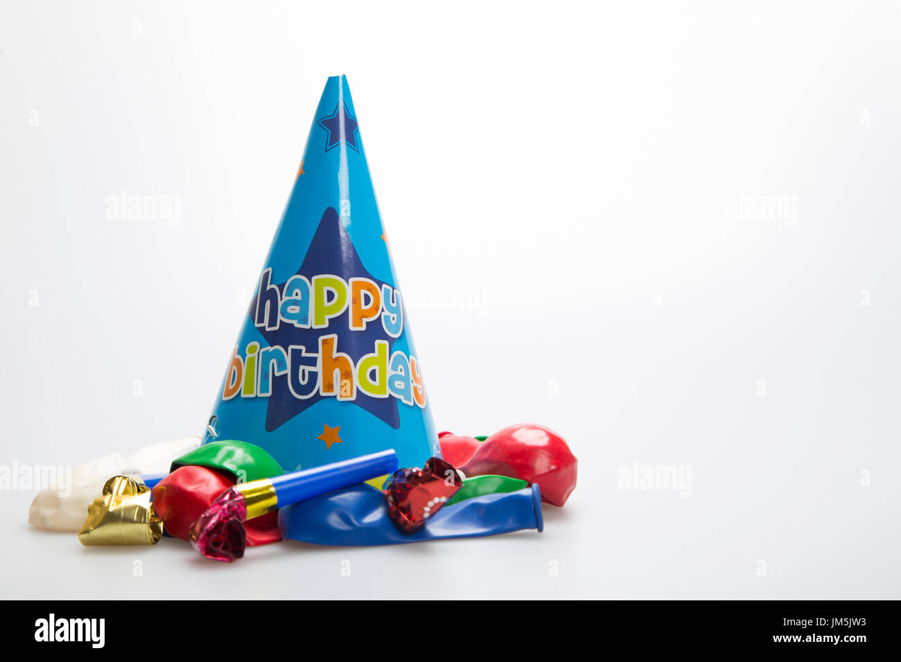 Blue party hat with balloons and party blowers Stock Photo - Alamy