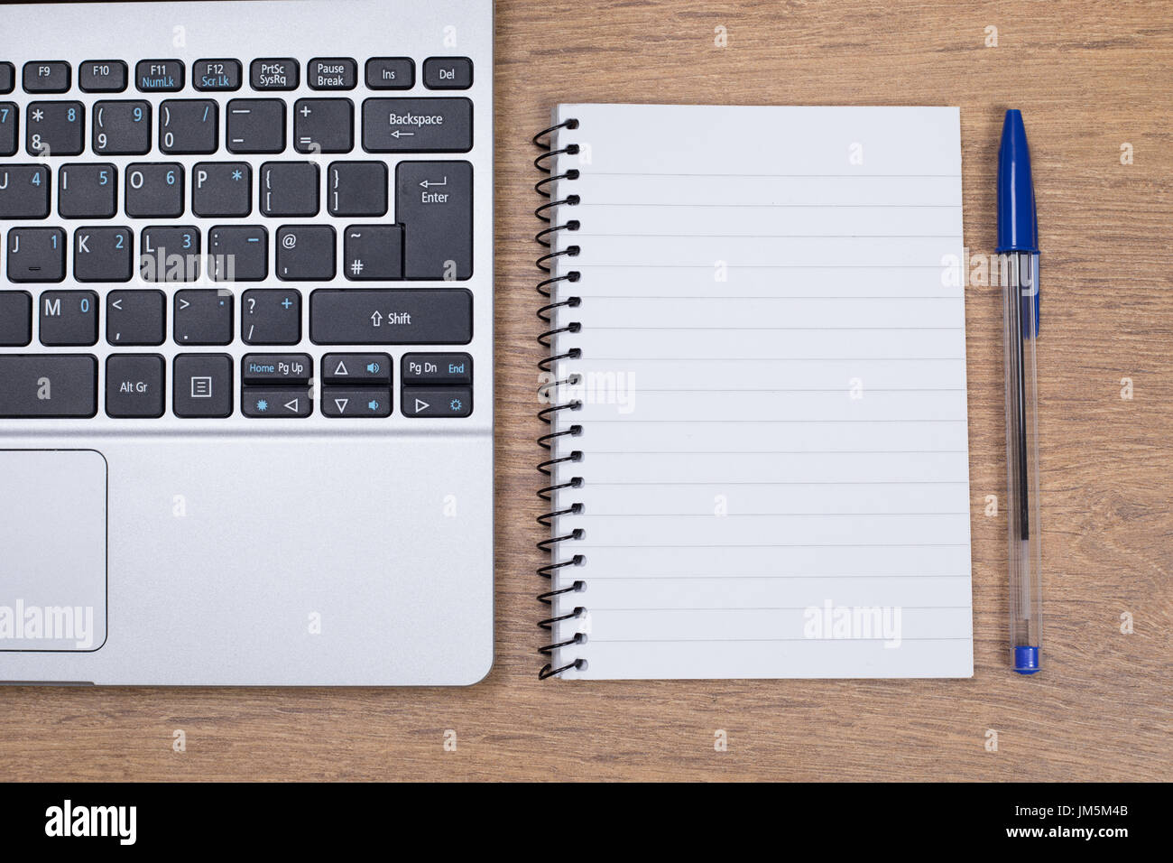 blank notepad with blue pen next to an open laptop Stock Photo - Alamy