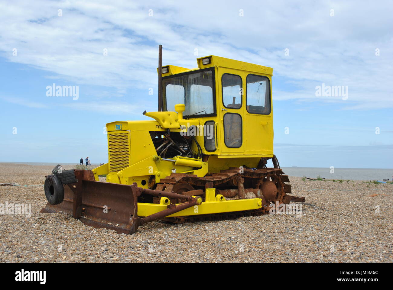 Bright yellow mini catapulted bulldozer on Aldeburge beach Stock Photo ...