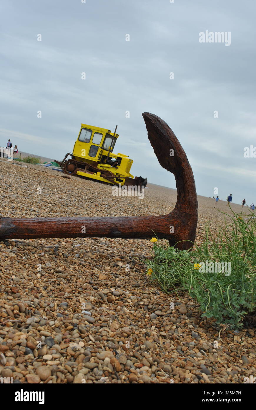 Bright yellow mini catapulted bulldozer on Aldeburge beach with old ...