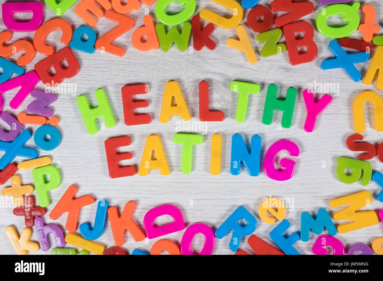 Magnet letters make the words healthy eating and create bright colorful ...
