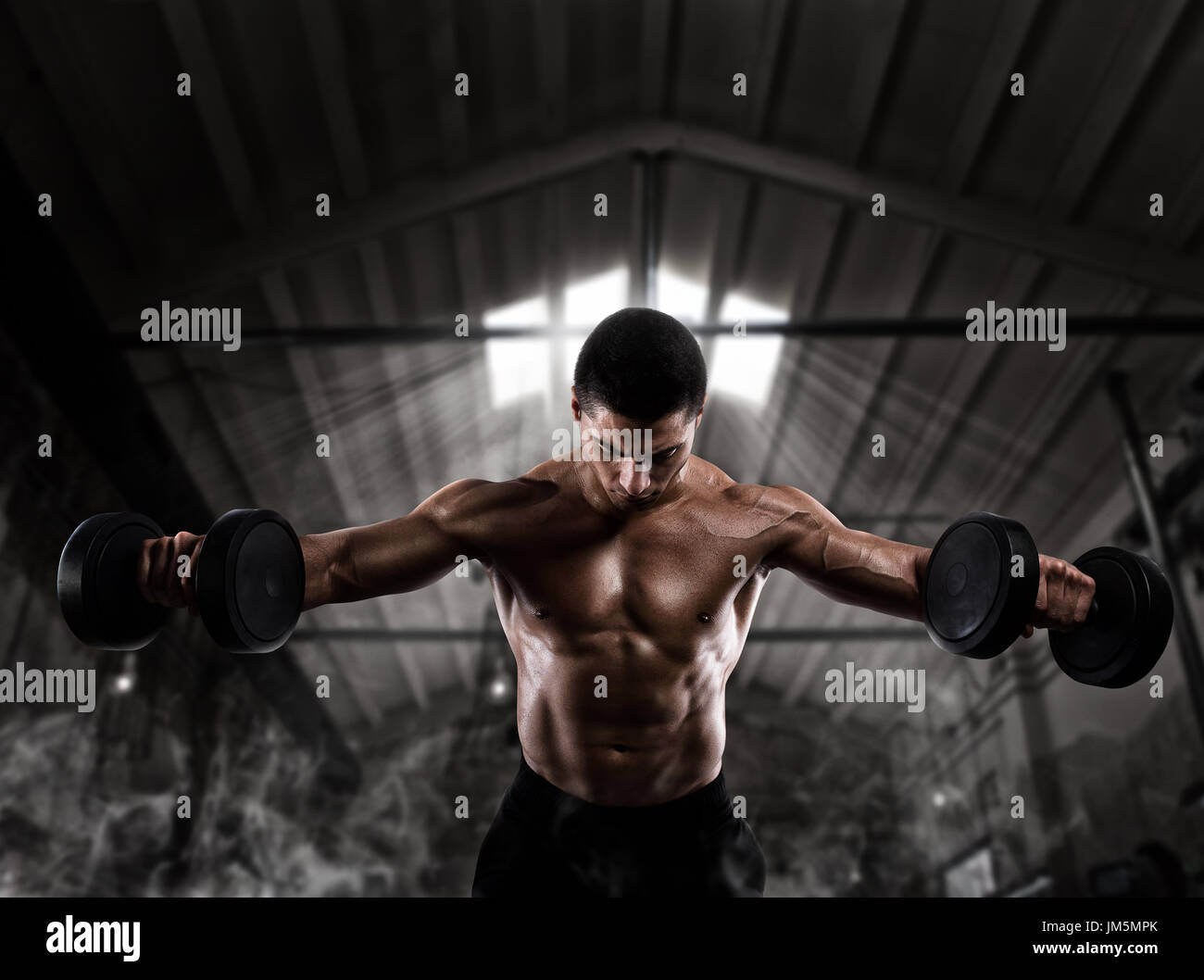 Athletic man training biceps at the gym Stock Photo - Alamy