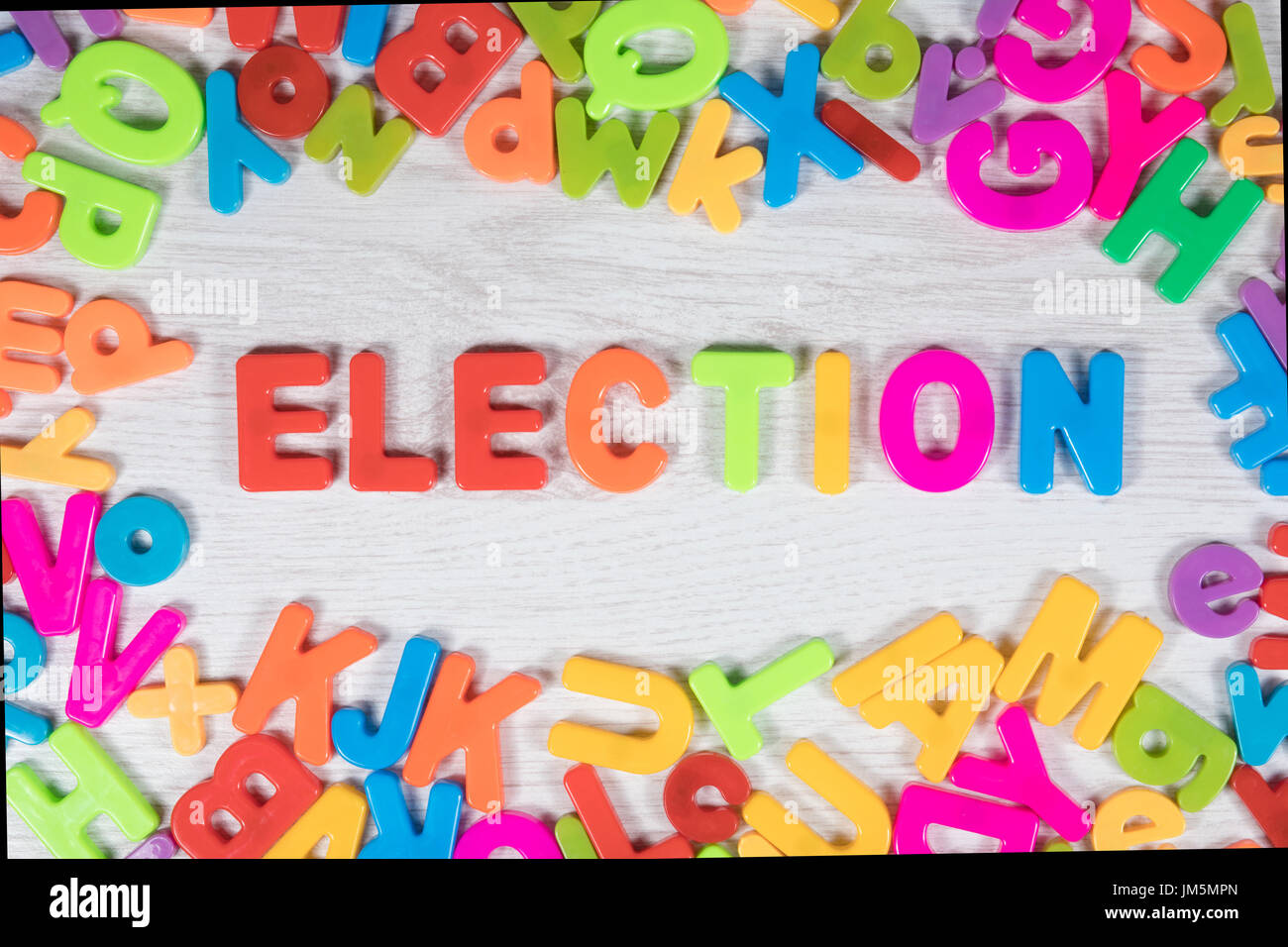 Brightly colored magnet letters create border around the word election ...