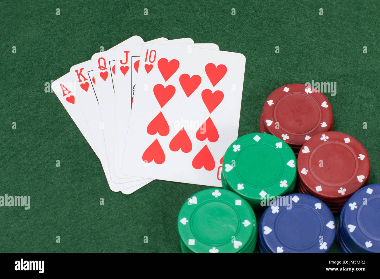 Overhead view of green felt covered poker table with stacked betting ...