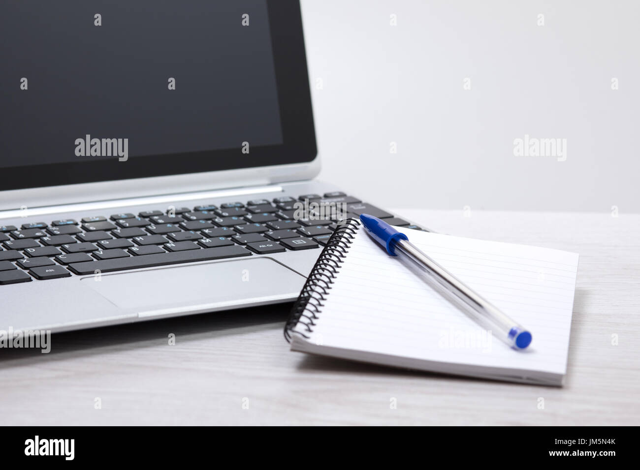 Online study or e-learning concept with a blank notepad and ballpoint ...