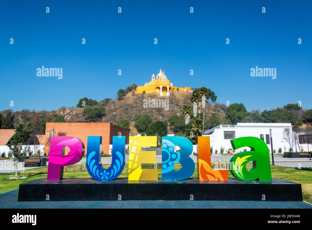 Puebla sign with Our Lady of Remedies on a hill in the background in ...