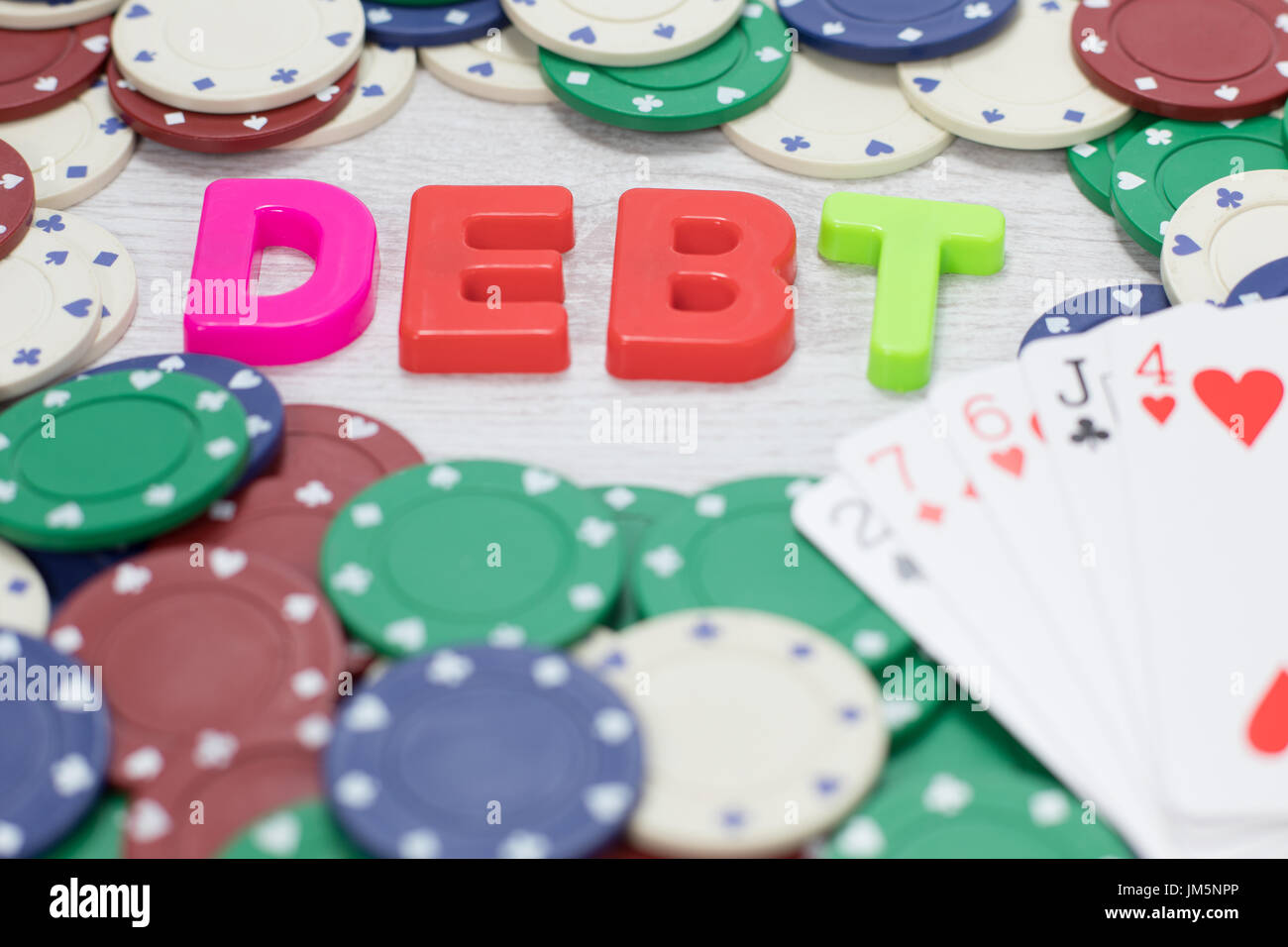 Losing poker hand resulting in gambling debt concept with colorful ...