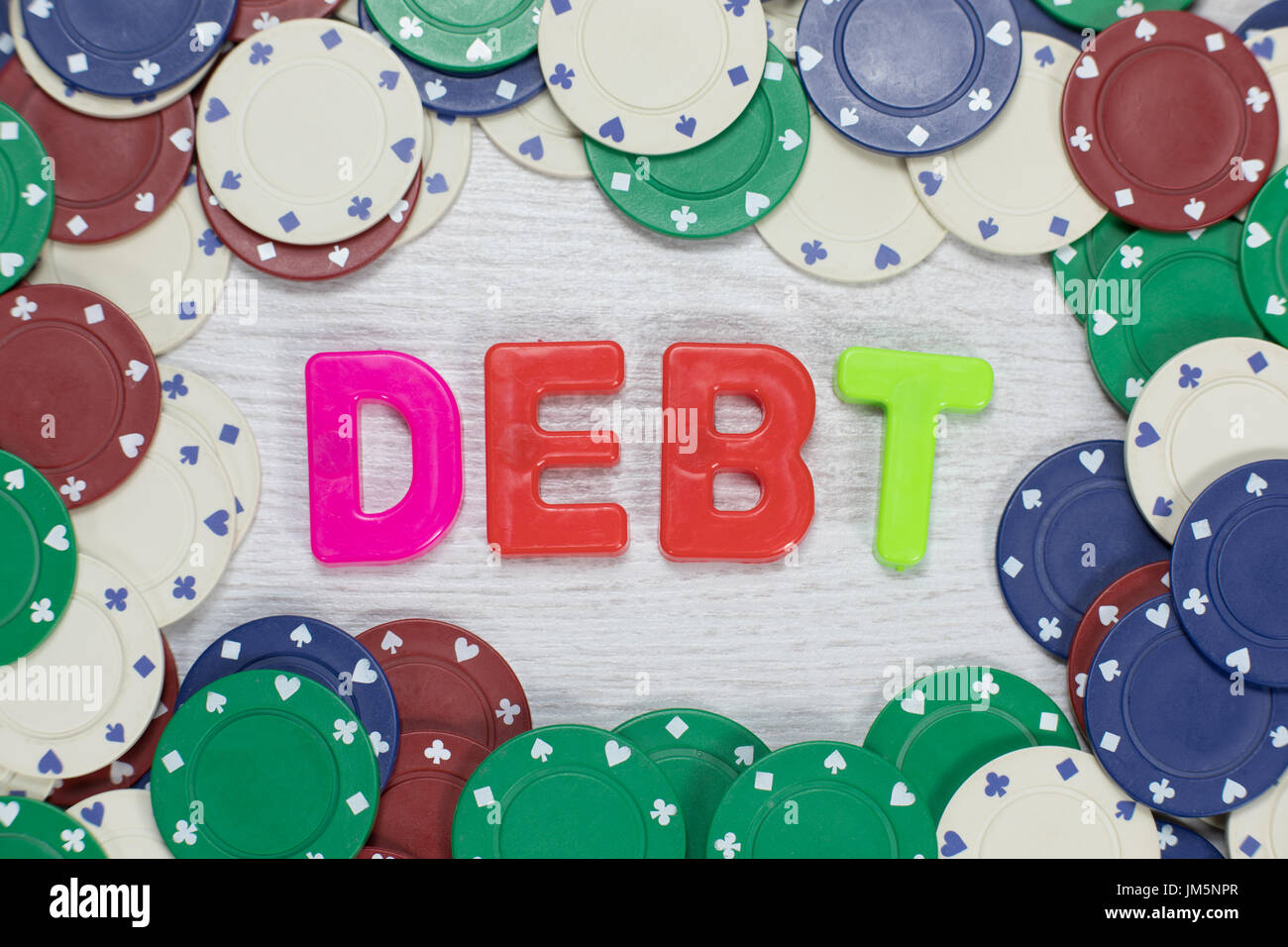 Debt resulting from gambling concept with colorful alphabet letters ...