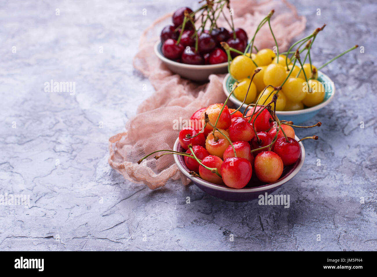Different type of colorful cherries. Selective focus Stock Photo - Alamy