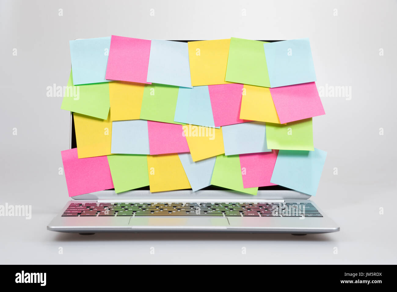 Colorful blank sticky memos completely covering an open laptop screen ...